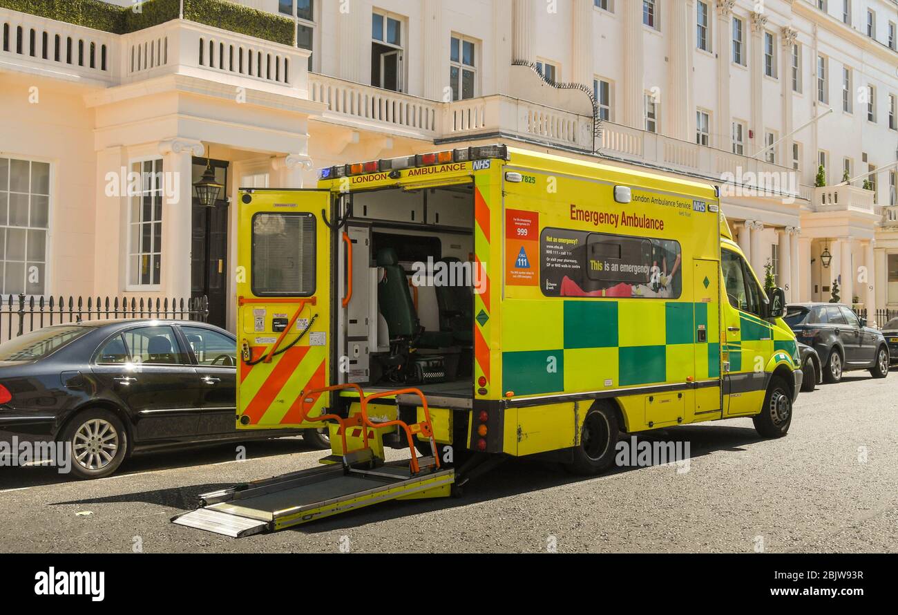 LONDON, ENGLAND - JULY 2018: Ambulance on an emergency call parked on a ...