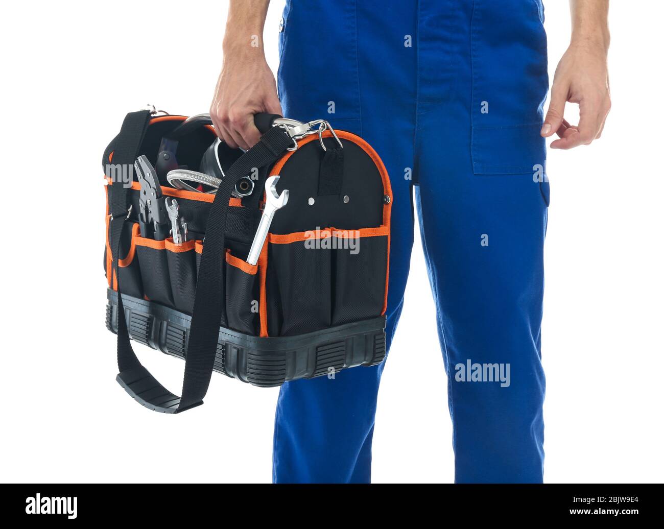 Young plumber in uniform with tool bag on white background Stock Photo ...
