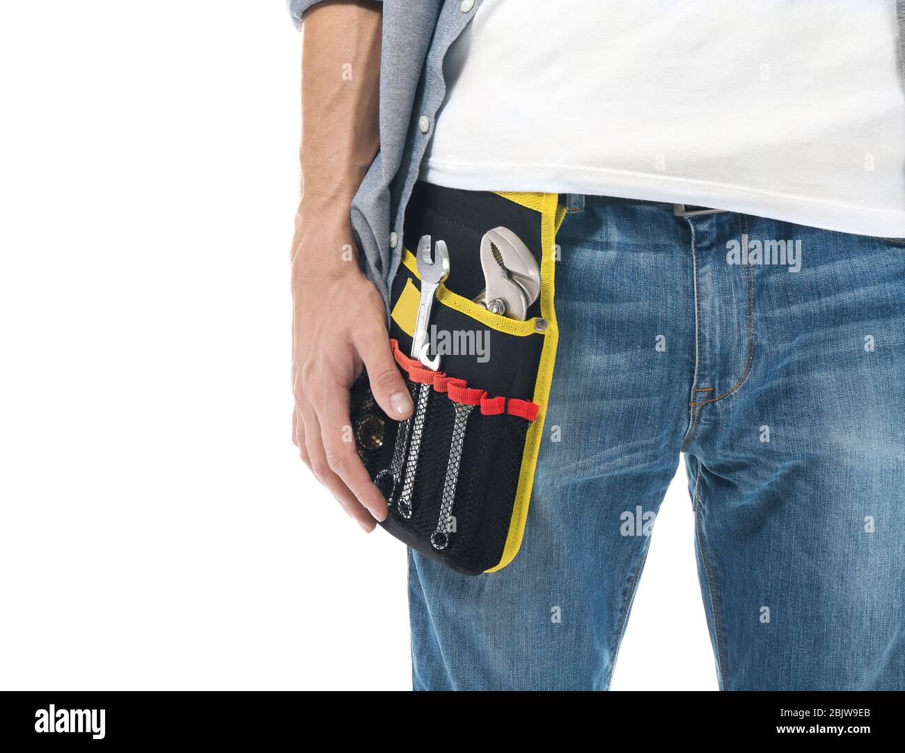 Young plumber with tool belt on white background Stock Photo - Alamy