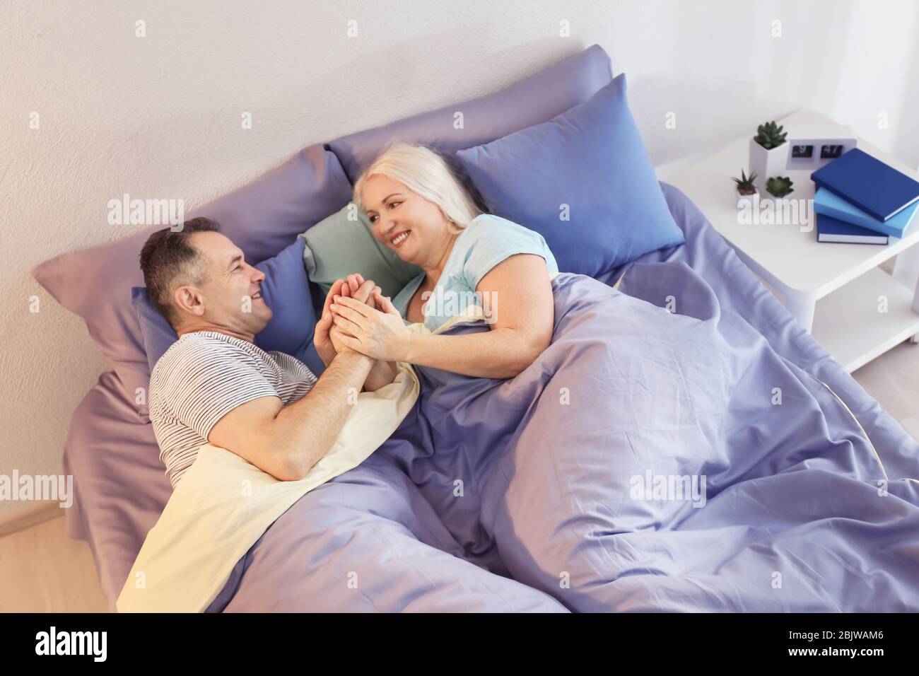 Senior couple in bed together Stock Photo - Alamy