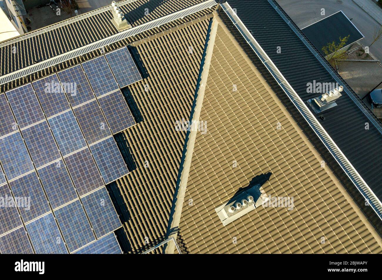 Aerial view of solar photovoltaic panels on a roof top of residential ...