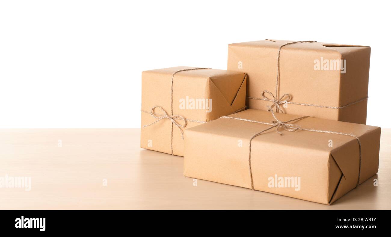 Parcel gift boxes on wooden table against white background Stock Photo ...