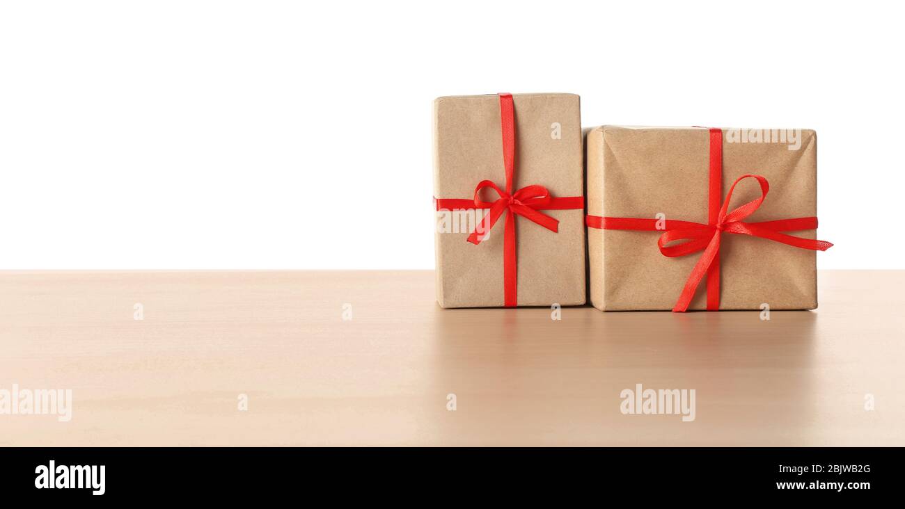 Parcel gift boxes on wooden table against white background Stock Photo ...