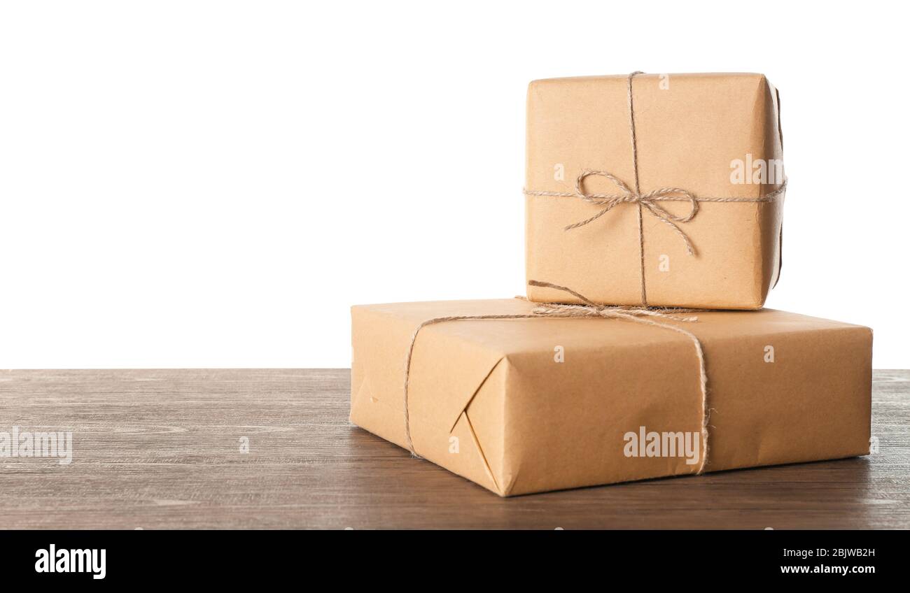 Parcel gift boxes on wooden table against white background Stock Photo ...
