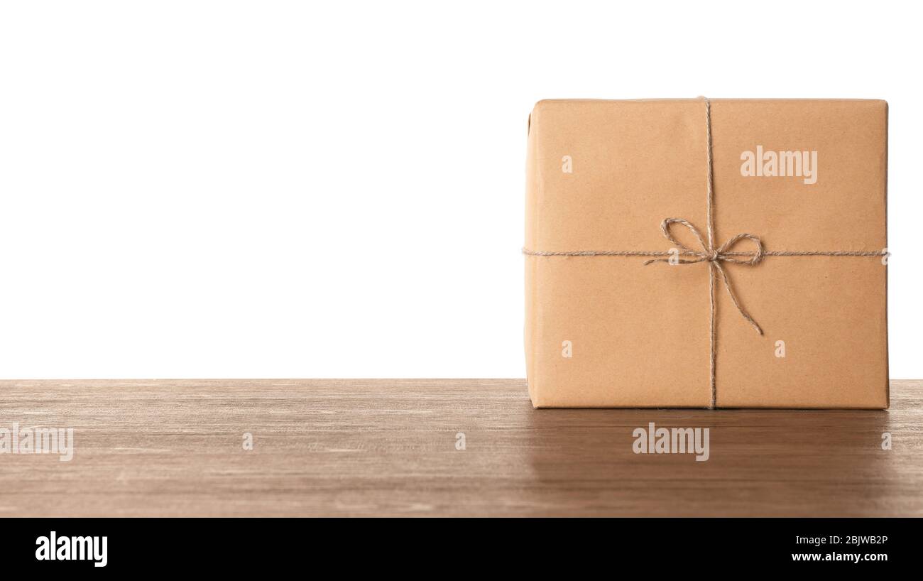 Parcel gift box on wooden table against white background Stock Photo ...