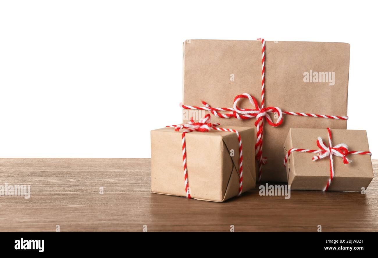 Parcel gift boxes on wooden table against white background Stock Photo ...