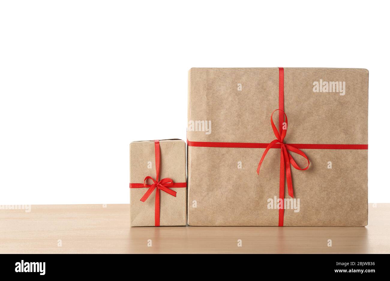 Parcel gift boxes on wooden table against white background Stock Photo ...