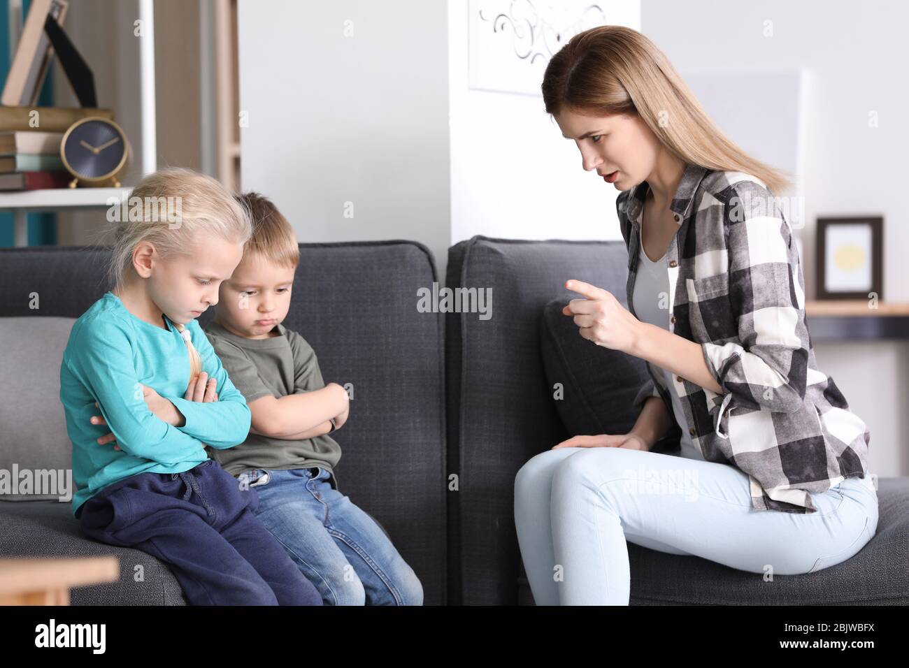 Mother scolding her little children at home. Family conflict Stock Photo - Alamy