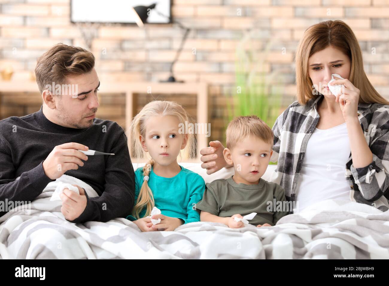 Sick family in bed at home Stock Photo - Alamy