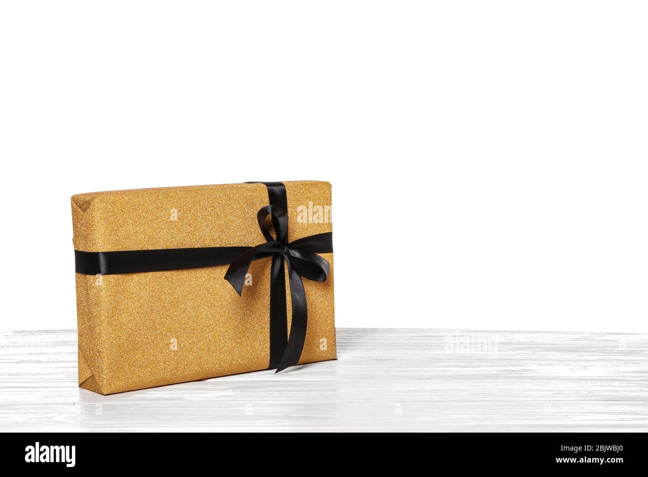 Beautiful gift box on table against white background Stock Photo - Alamy