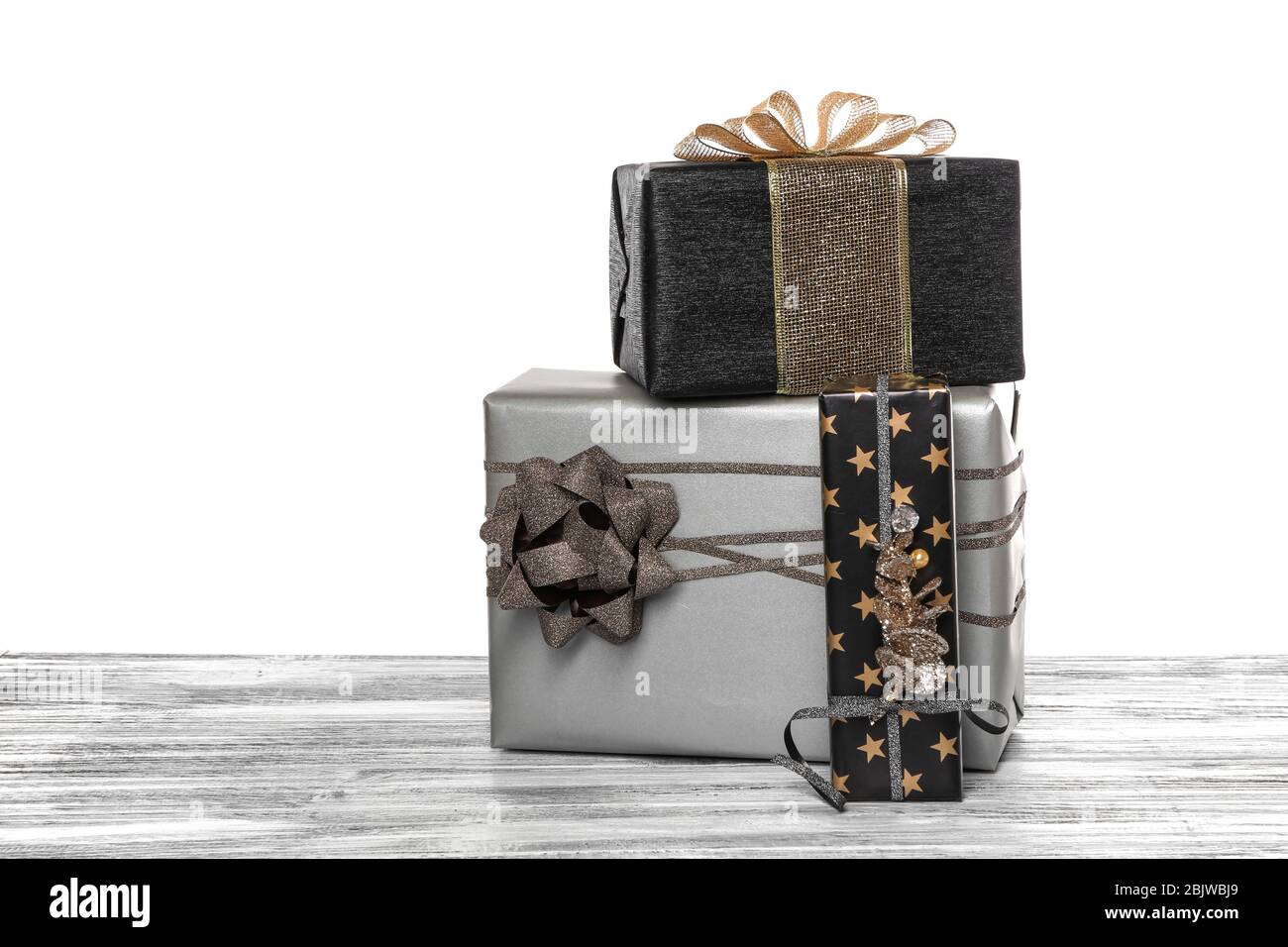 Beautiful gift boxes on table against white background Stock Photo - Alamy