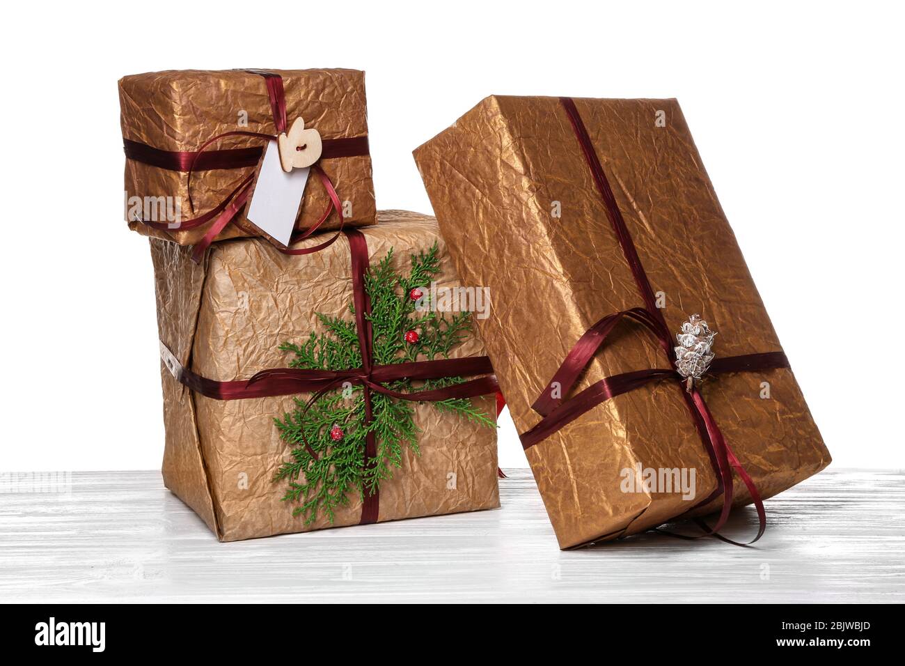 Beautiful Christmas gift boxes on table against white background Stock ...