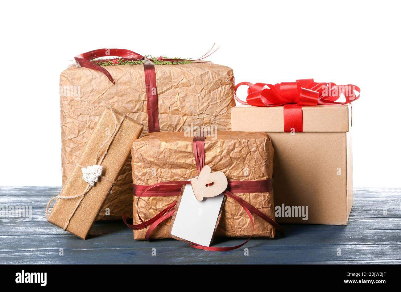 Beautiful Christmas gift boxes on table against white background Stock ...
