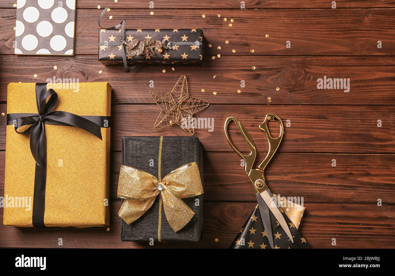 Beautifully decorated gift boxes on wooden background, top view Stock ...