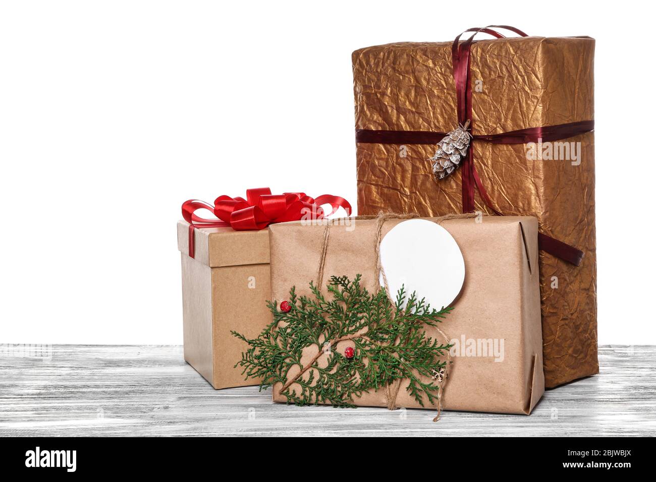 Beautiful Christmas gift boxes on table against white background Stock ...