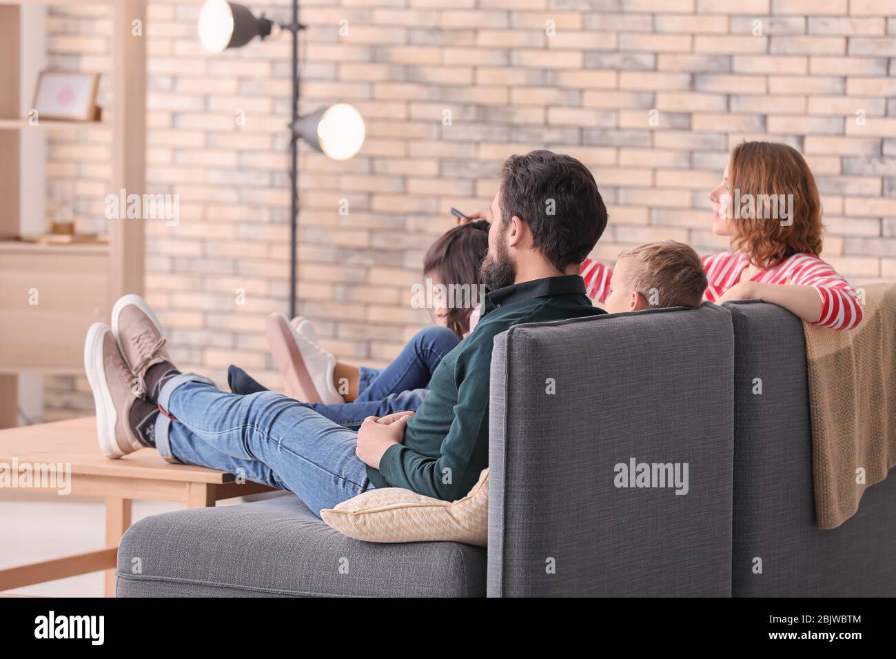 Happy family watching TV at home Stock Photo - Alamy