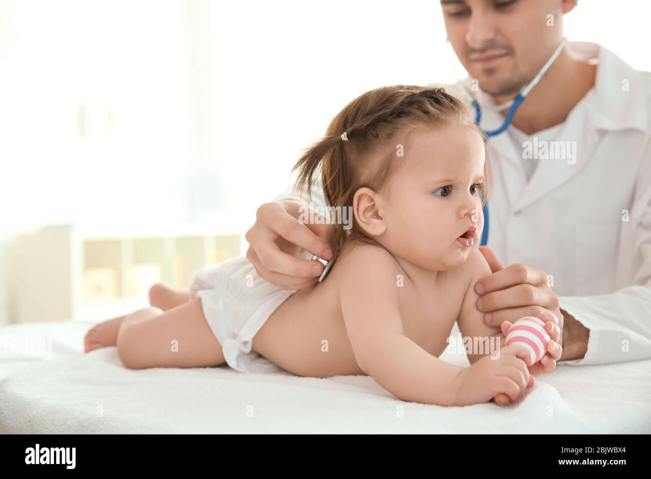 Doctor examining baby girl in clinic Stock Photo - Alamy