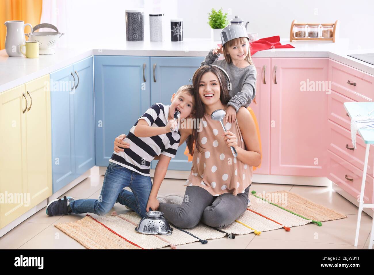 Happy family playing with kitchenware at home Stock Photo - Alamy