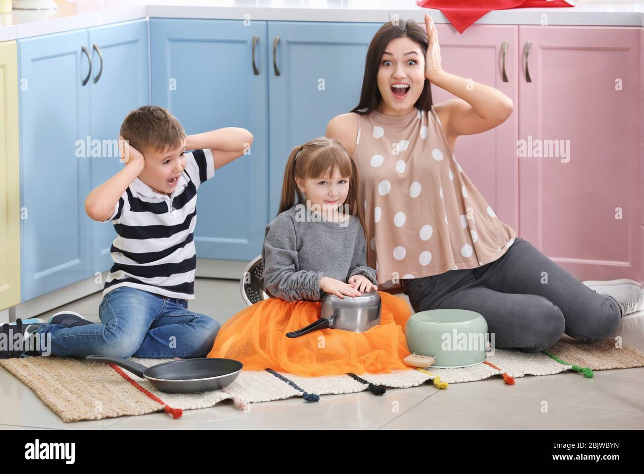 Happy family playing with kitchenware at home Stock Photo - Alamy