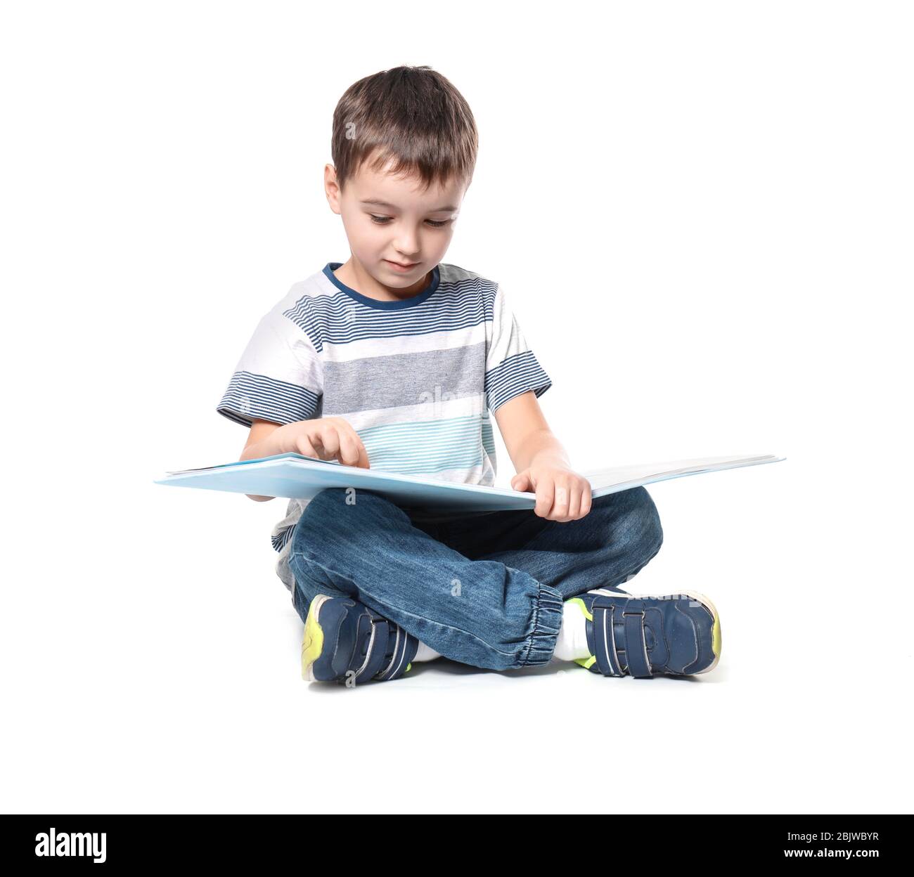 Cute little boy reading book on white background Stock Photo - Alamy