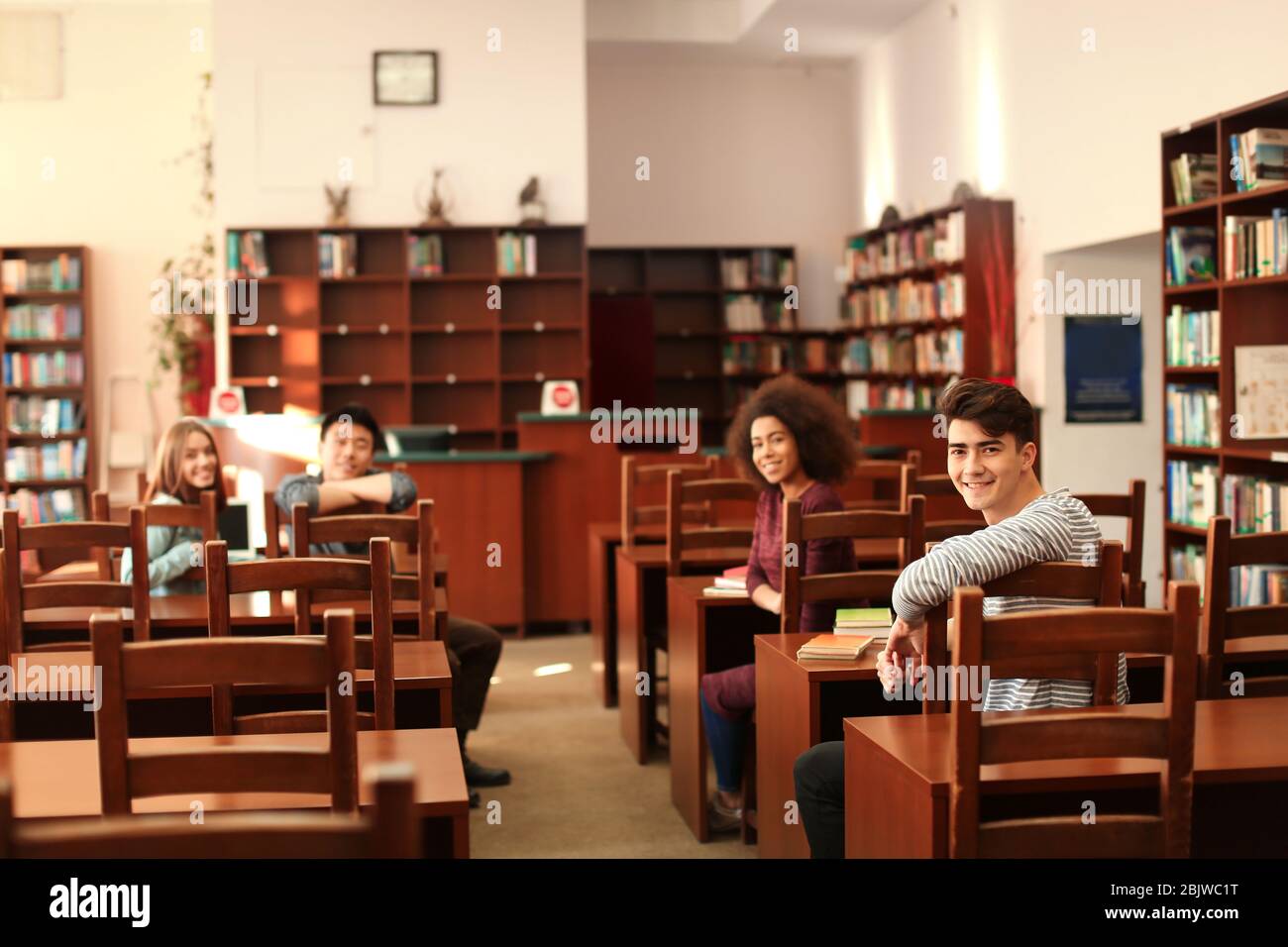 Group of students studying in library Stock Photo - Alamy