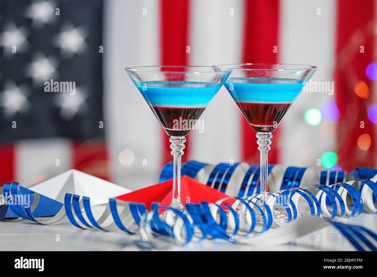 Cocktails in colors of American flag on table against blurred ...