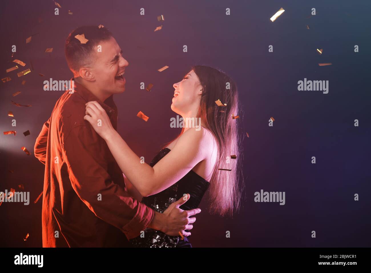 Young couple dancing together in night club Stock Photo - Alamy