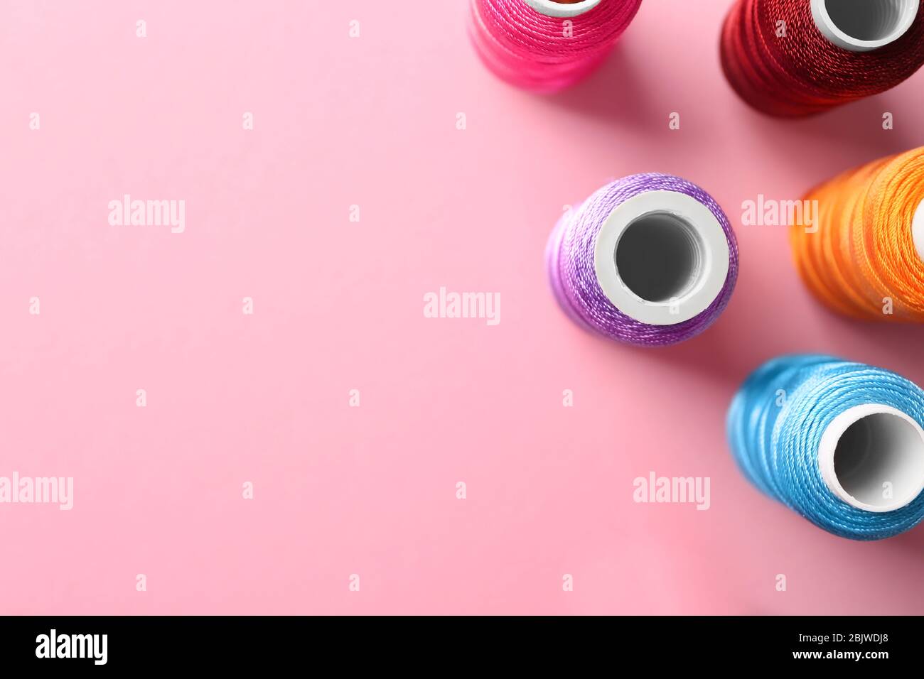 Set of sewing threads on color background Stock Photo - Alamy