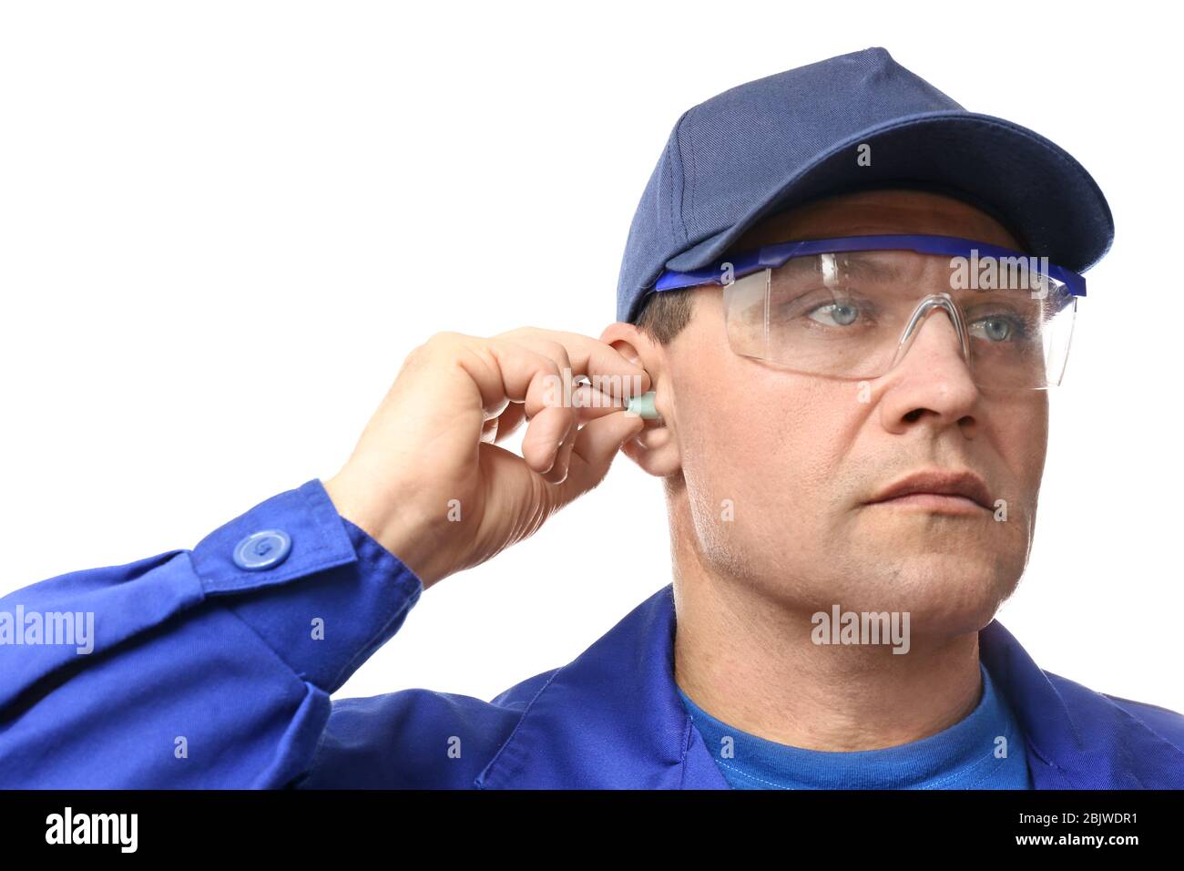 Male worker with ear plug and goggles on white background. Health and ...