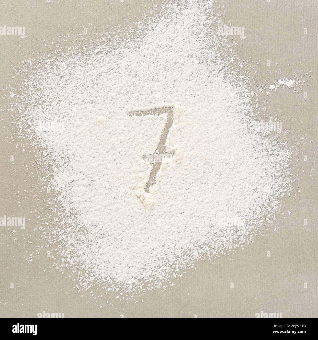 Figure SEVEN written on flour Stock Photo - Alamy