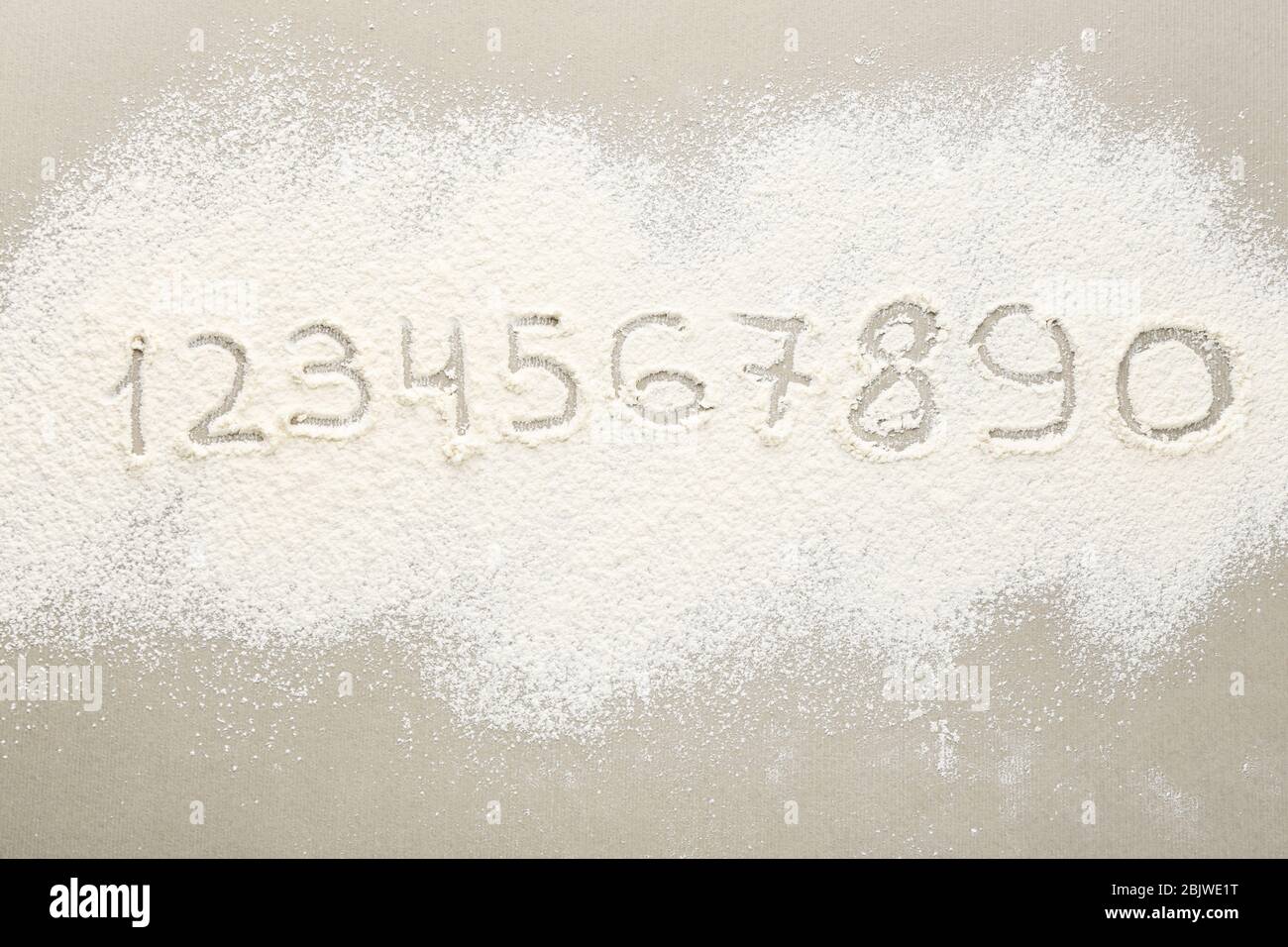 Set of figures written on flour Stock Photo - Alamy