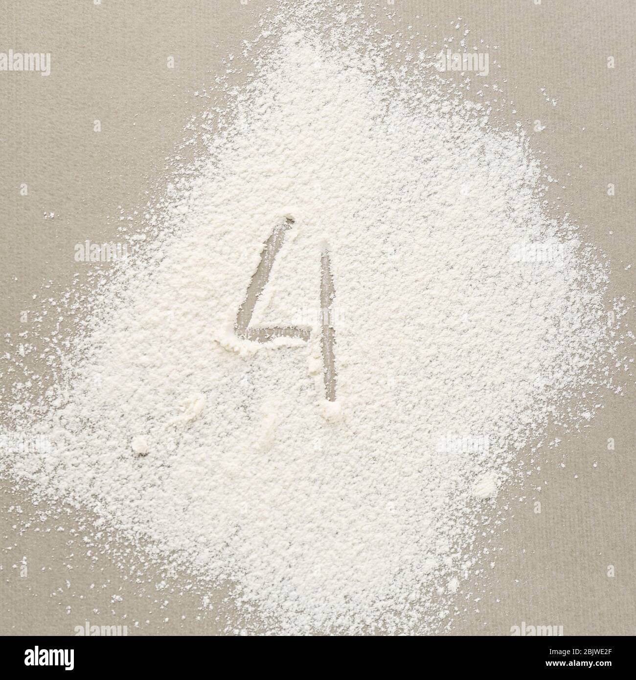 Figure FOUR written on flour Stock Photo - Alamy