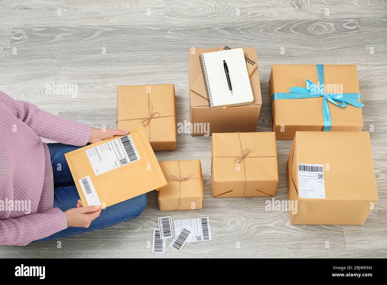 Woman preparing parcels shipment hi-res stock photography and images ...