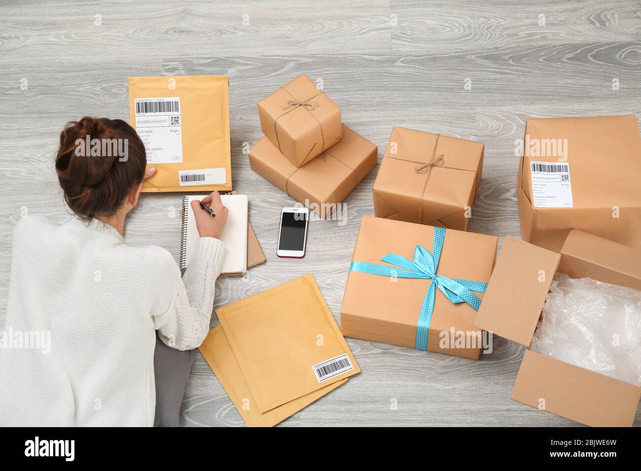 Woman preparing parcels shipment hi-res stock photography and images ...