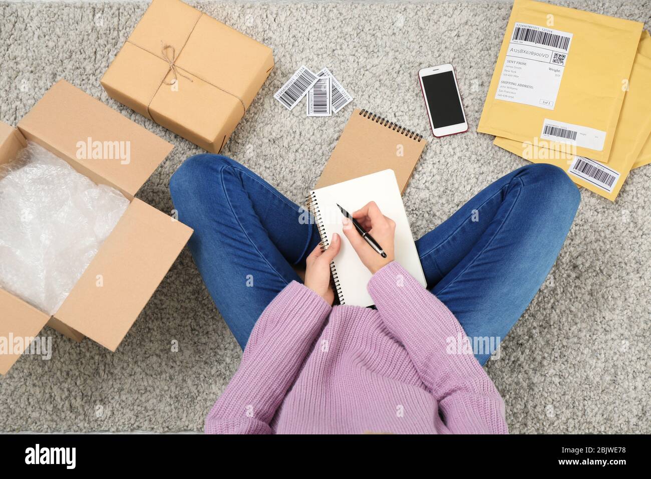 Woman preparing parcels shipment hi-res stock photography and images ...