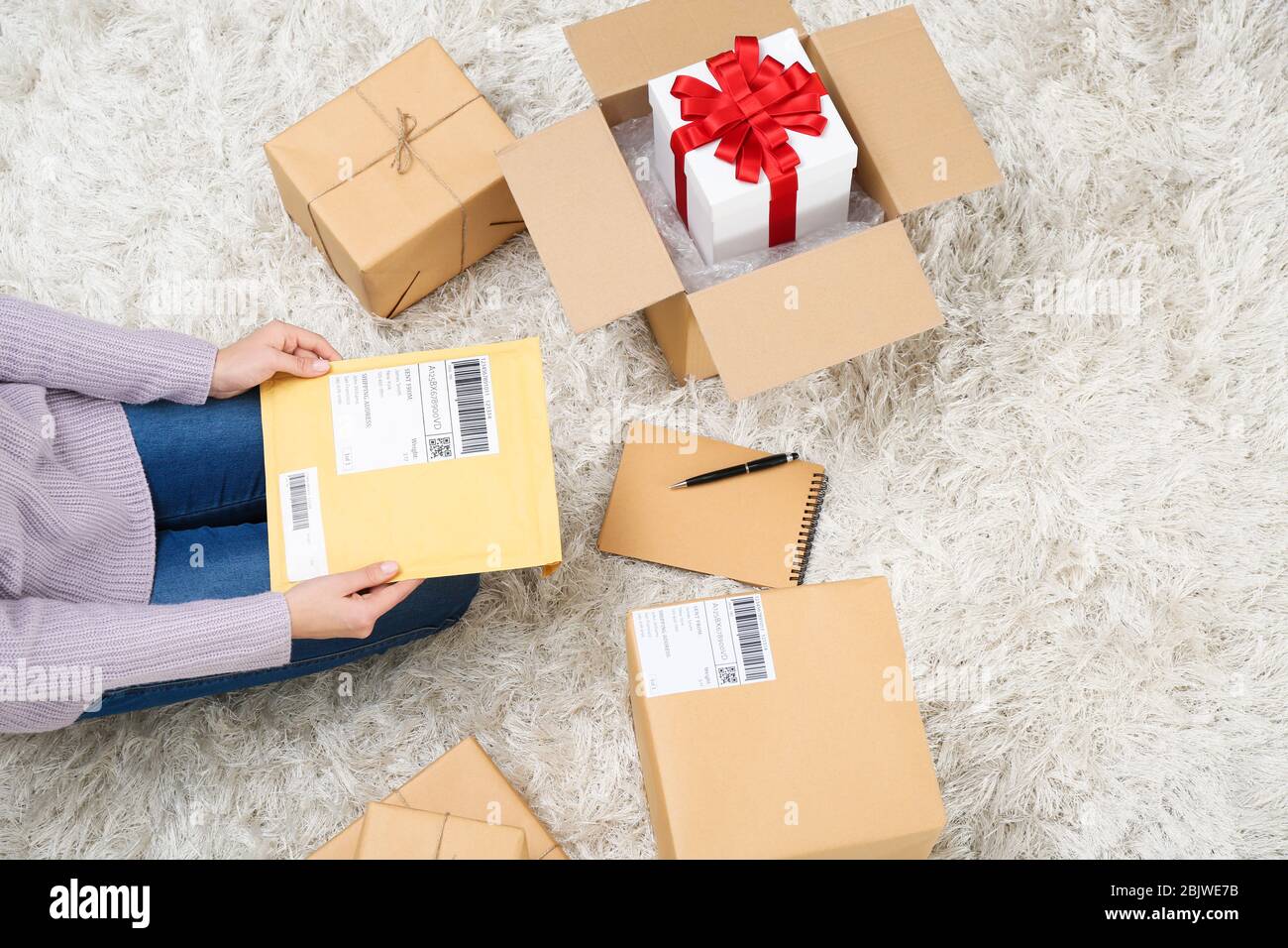Woman preparing parcels shipment hi-res stock photography and images ...