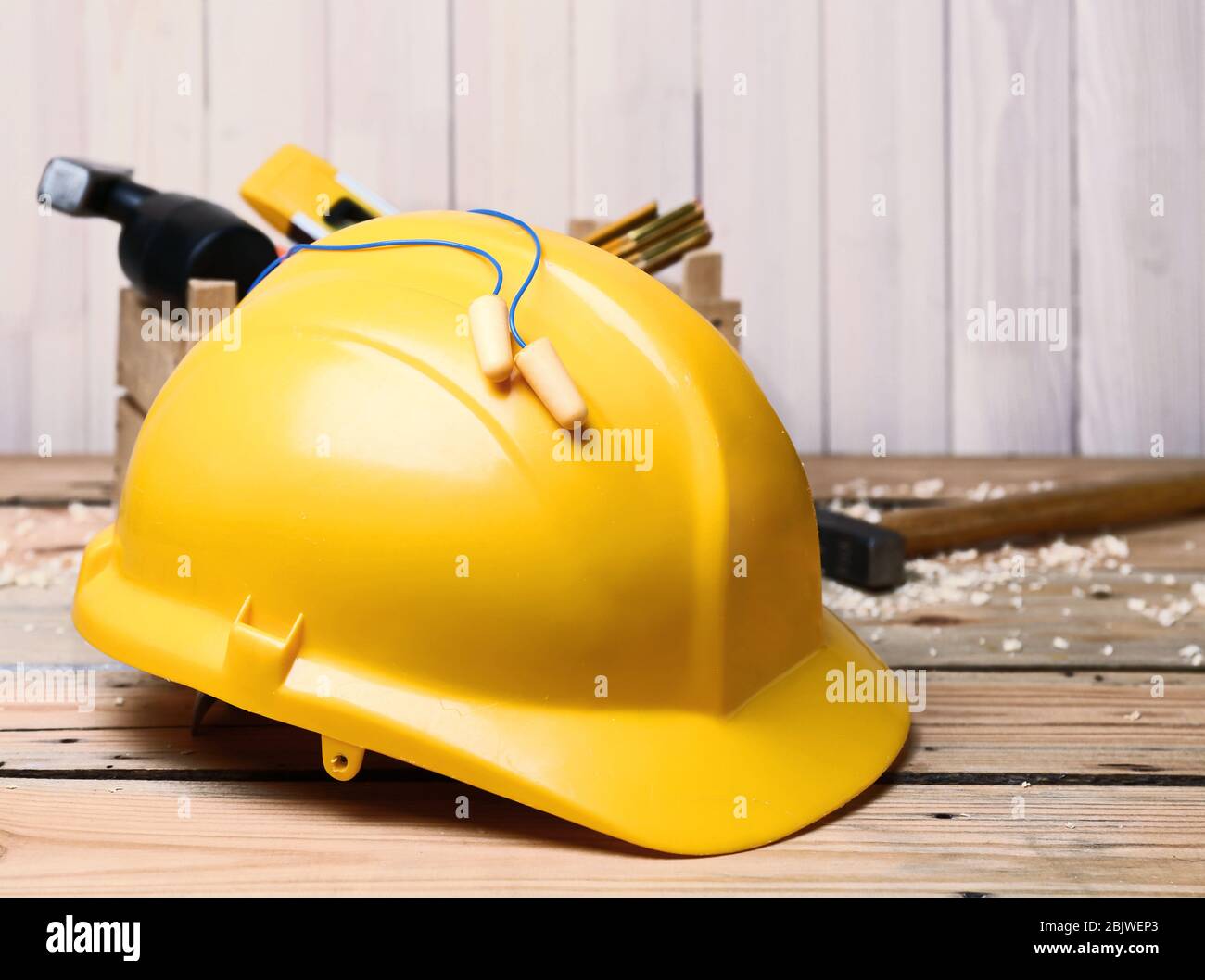 Hard hat and earplugs on table. Hearing protection equipment Stock ...
