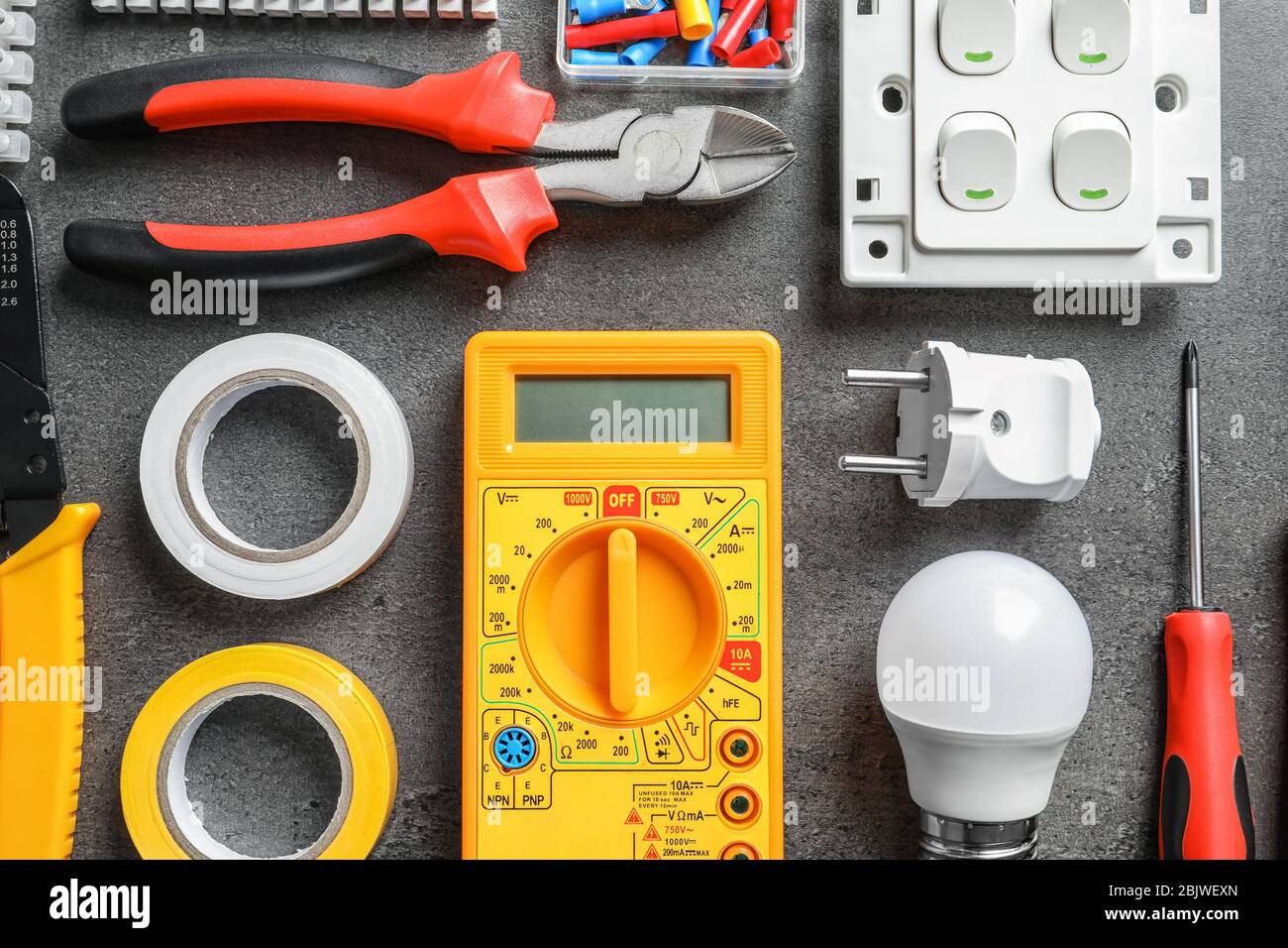 Different electrical tools on grey background Stock Photo - Alamy