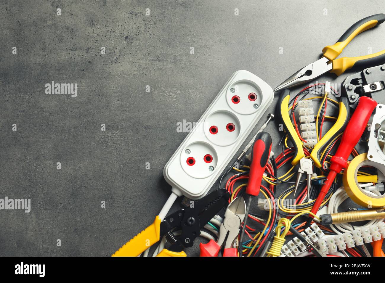 Different electrical tools on grey background Stock Photo - Alamy