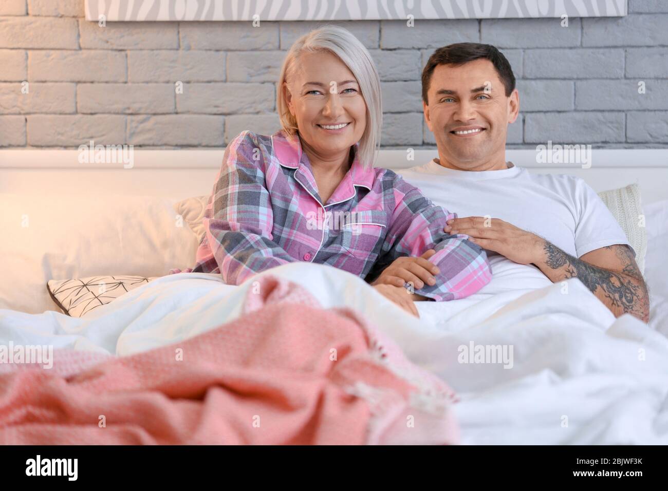 Mature couple in comfortable bed Stock Photo - Alamy