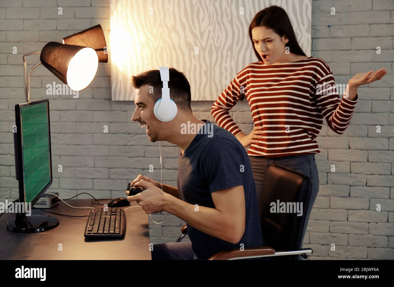 Young couple having conflict while playing video game at home Stock ...