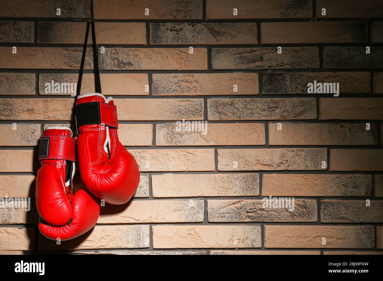 Boxing gloves on brick wall Stock Photo - Alamy