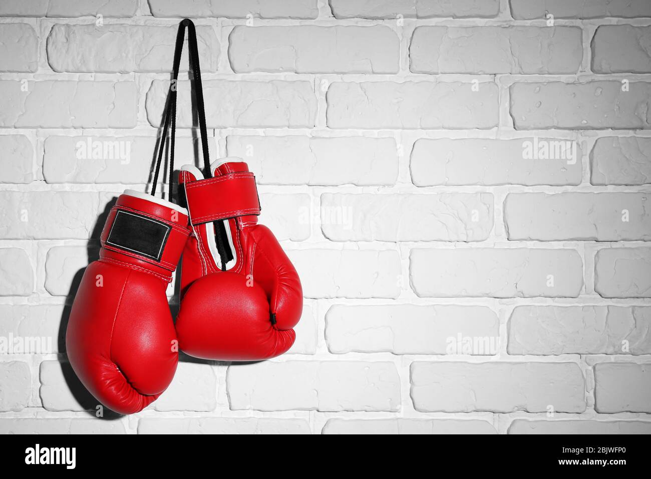 Boxing gloves on brick wall Stock Photo - Alamy