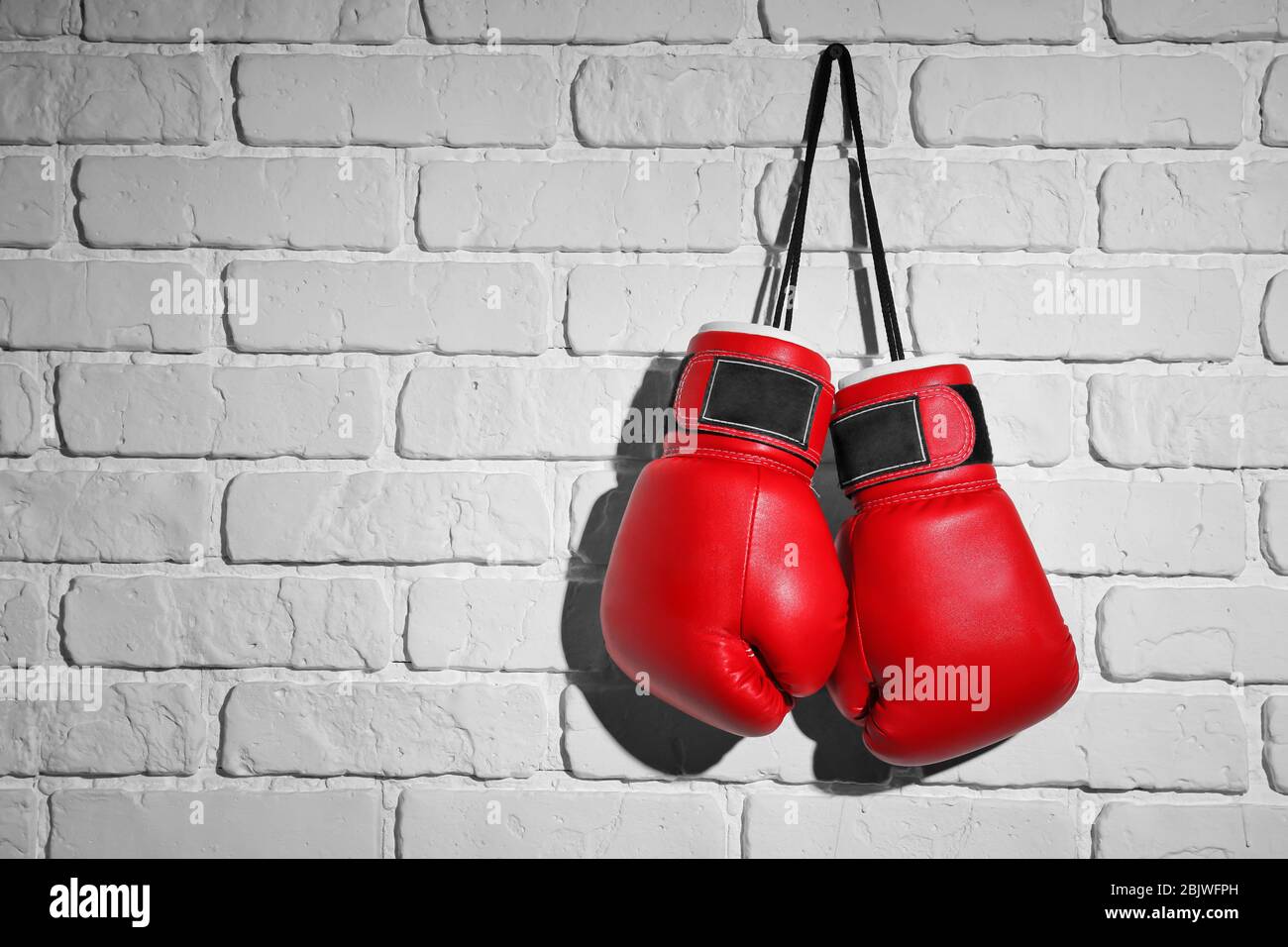 Boxing gloves on brick wall Stock Photo - Alamy
