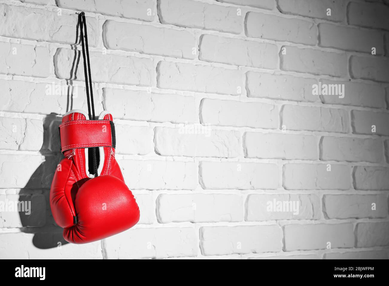 Boxing glove on brick wall Stock Photo - Alamy