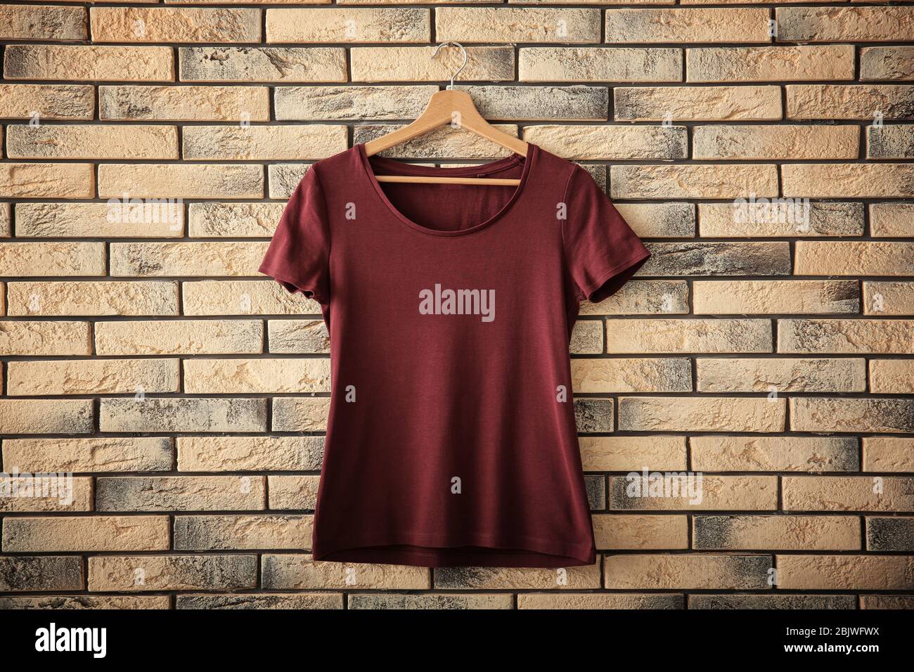 Color t-shirt on brick wall background. Mockup for design Stock Photo ...