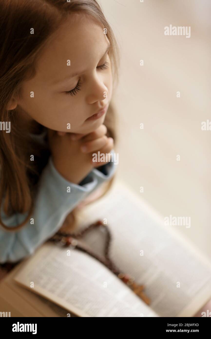 Religious Christian girl praying over Bible indoors Stock Photo - Alamy