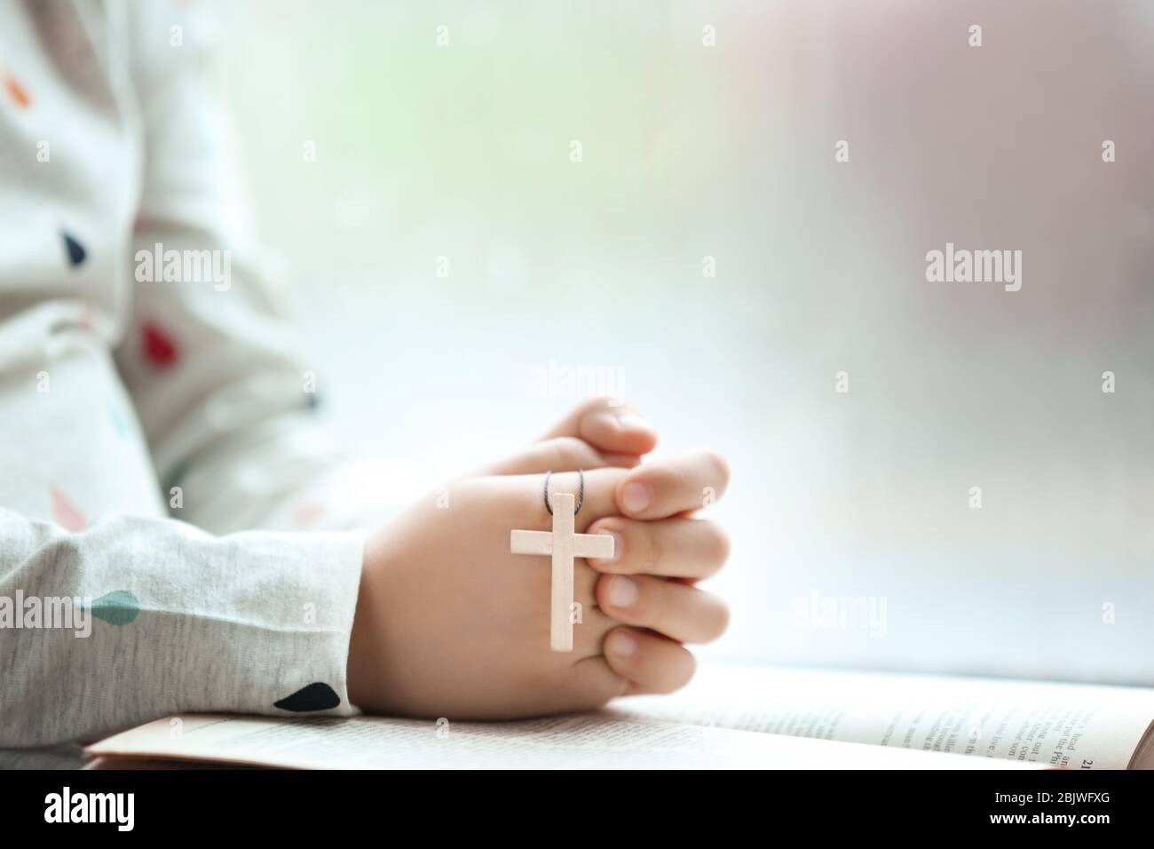 Religious Christian girl praying over Bible indoors, closeup Stock ...