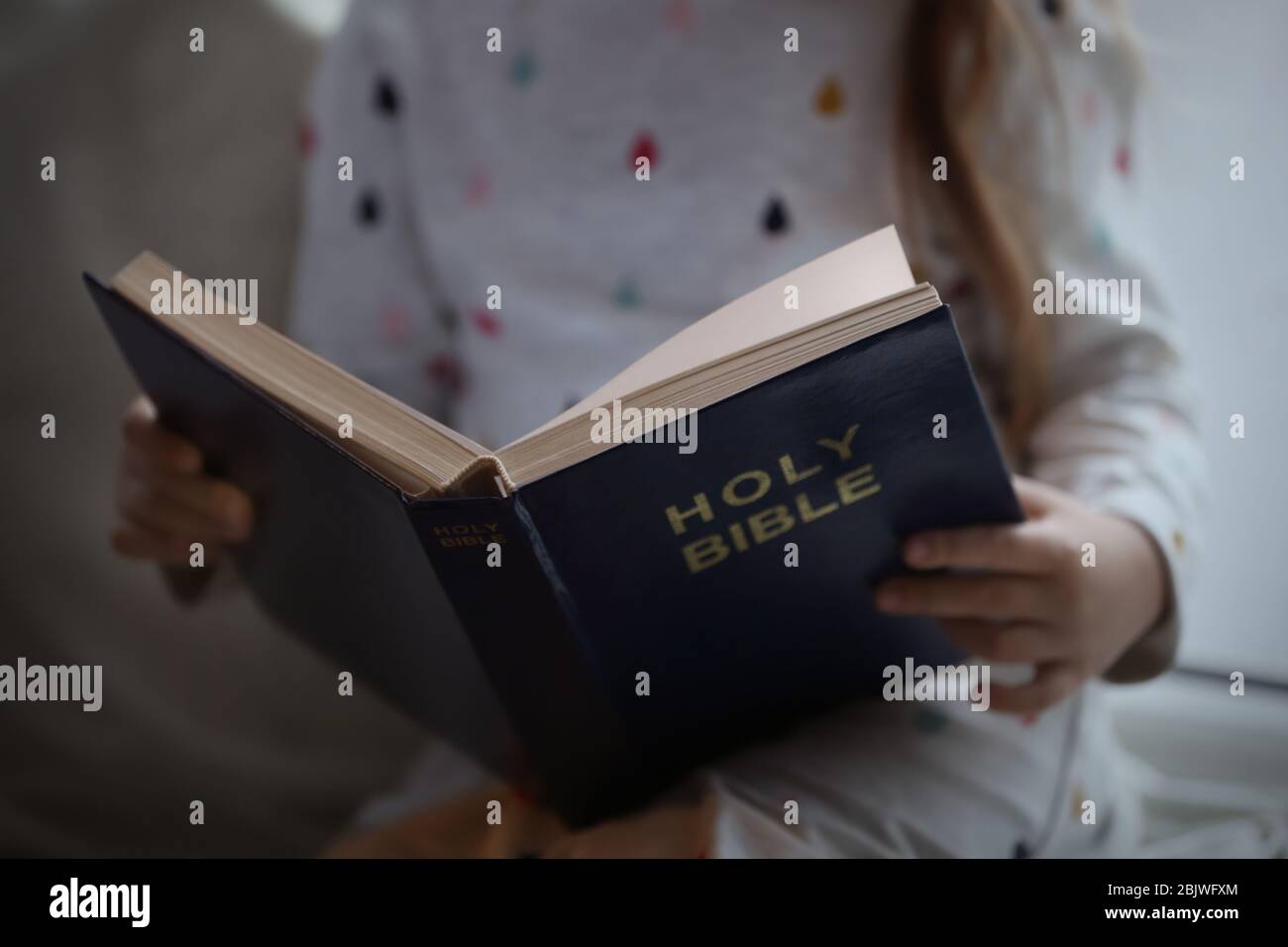 Religious Christian girl reading Bible indoors Stock Photo - Alamy