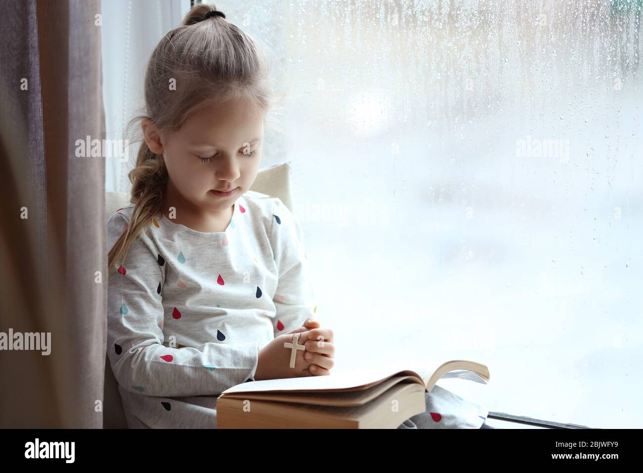 Religious Christian girl praying over Bible indoors Stock Photo - Alamy